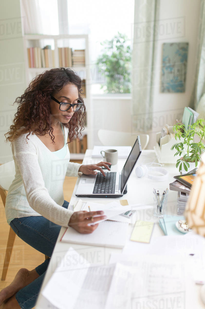 Woman paying bills via internet - Stock Photo - Dissolve