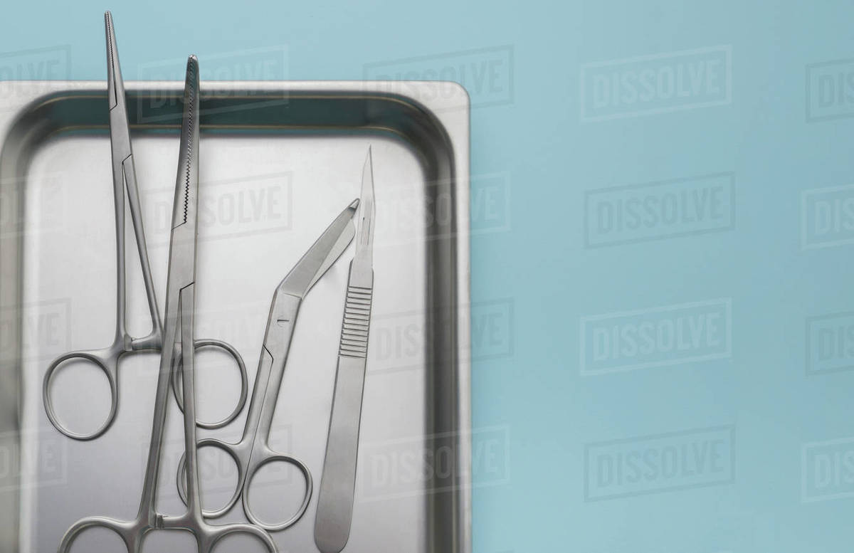 Forceps and scalpel on tray - Royalty-free Stock Photo | Dissolve