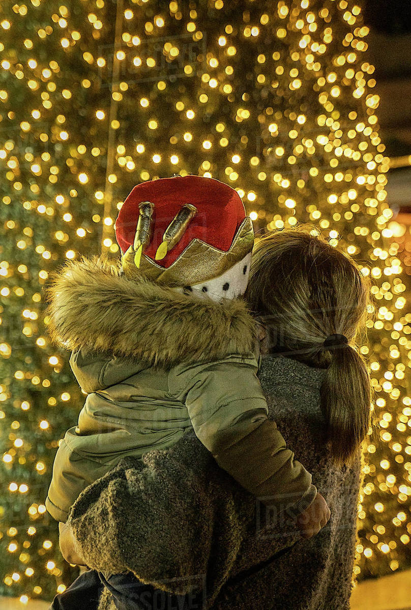 Mother and son watching illuminated Christmas tree - Stock Photo - Dissolve