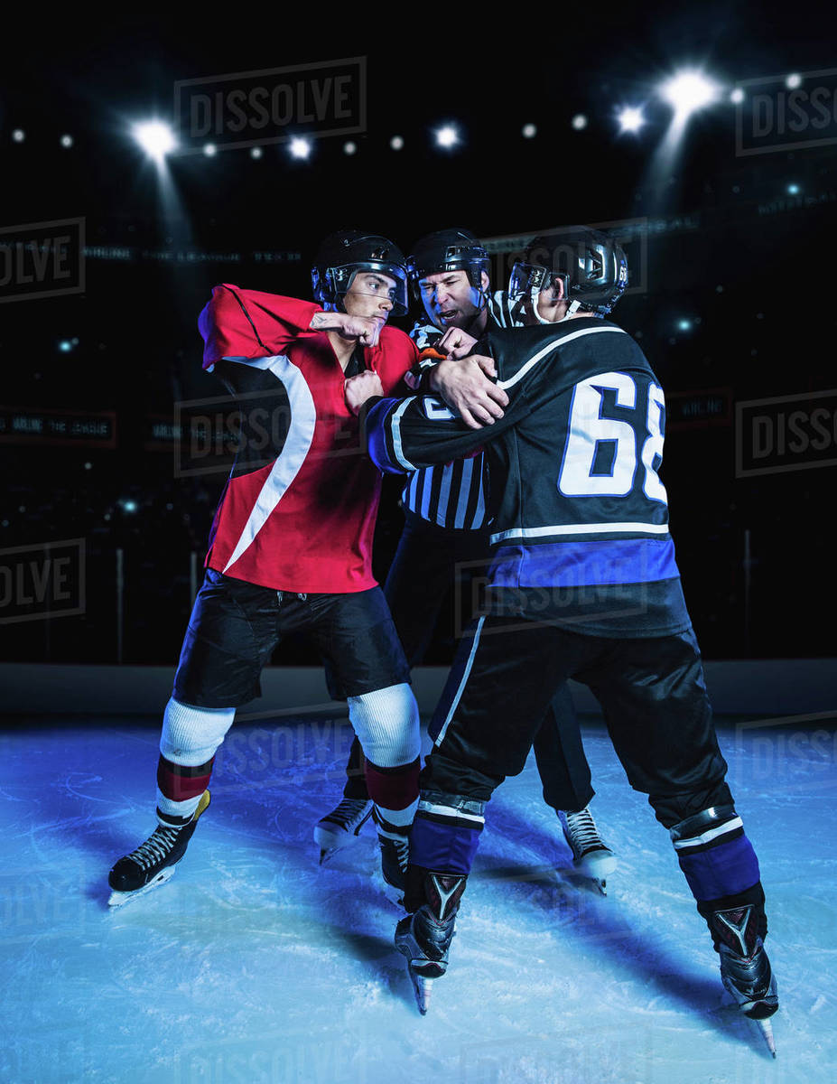 Referee separating fighting hockey players - Royalty-free Stock Photo ...