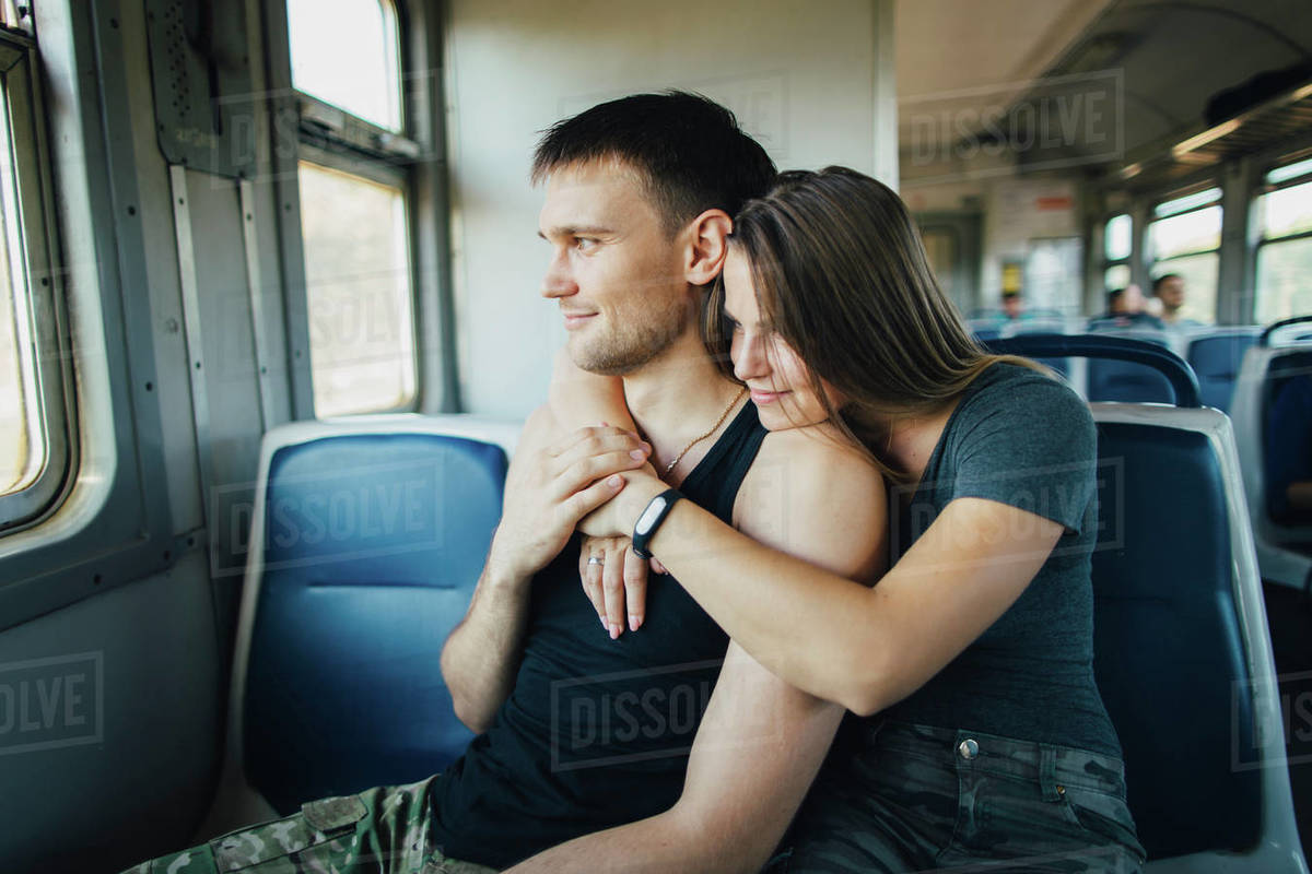 Young couple embracing in train - Royalty-free Stock Photo | Dissolve