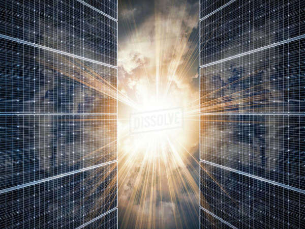 Sun shining through solar panels - Stock Photo - Dissolve