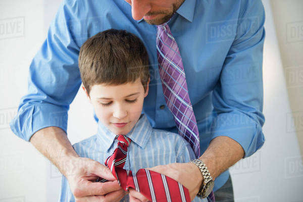 Father adjusting son's(8-9) tie - Royalty-free Stock Photo | Dissolve