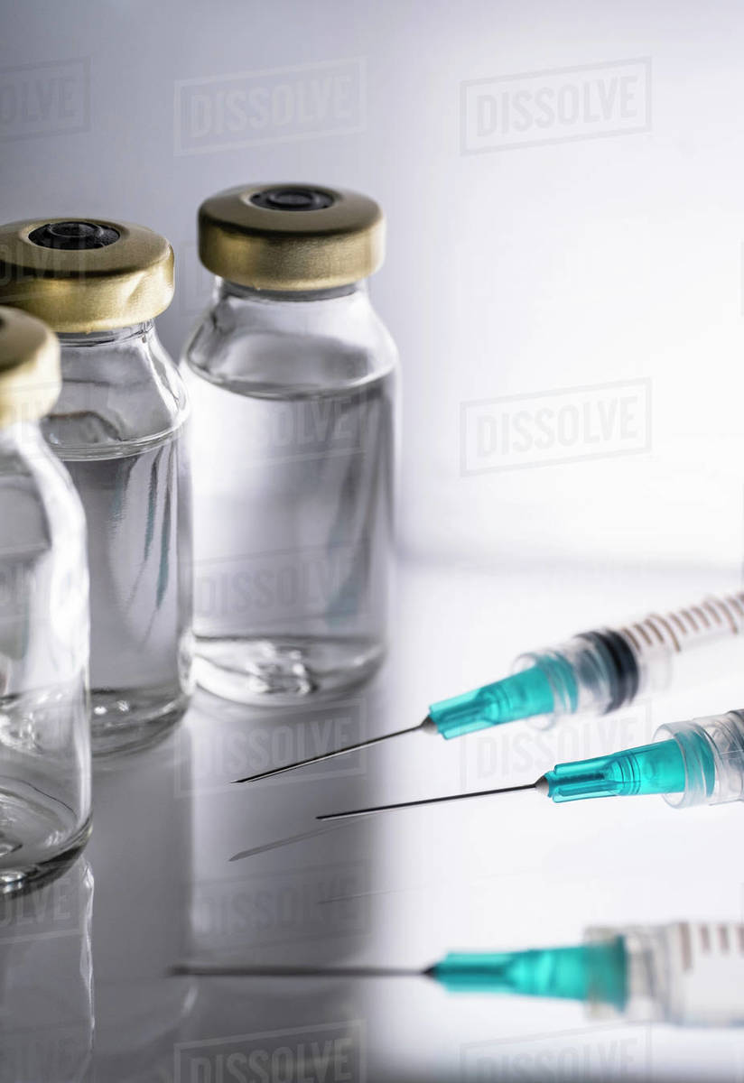 Studio shot of laboratory vials with liquid and syringes - Stock Photo ...