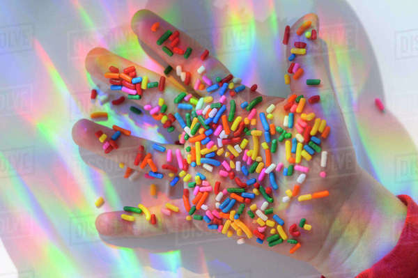 Hand holding sprinkles with colorful reflections - Royalty-free Stock ...