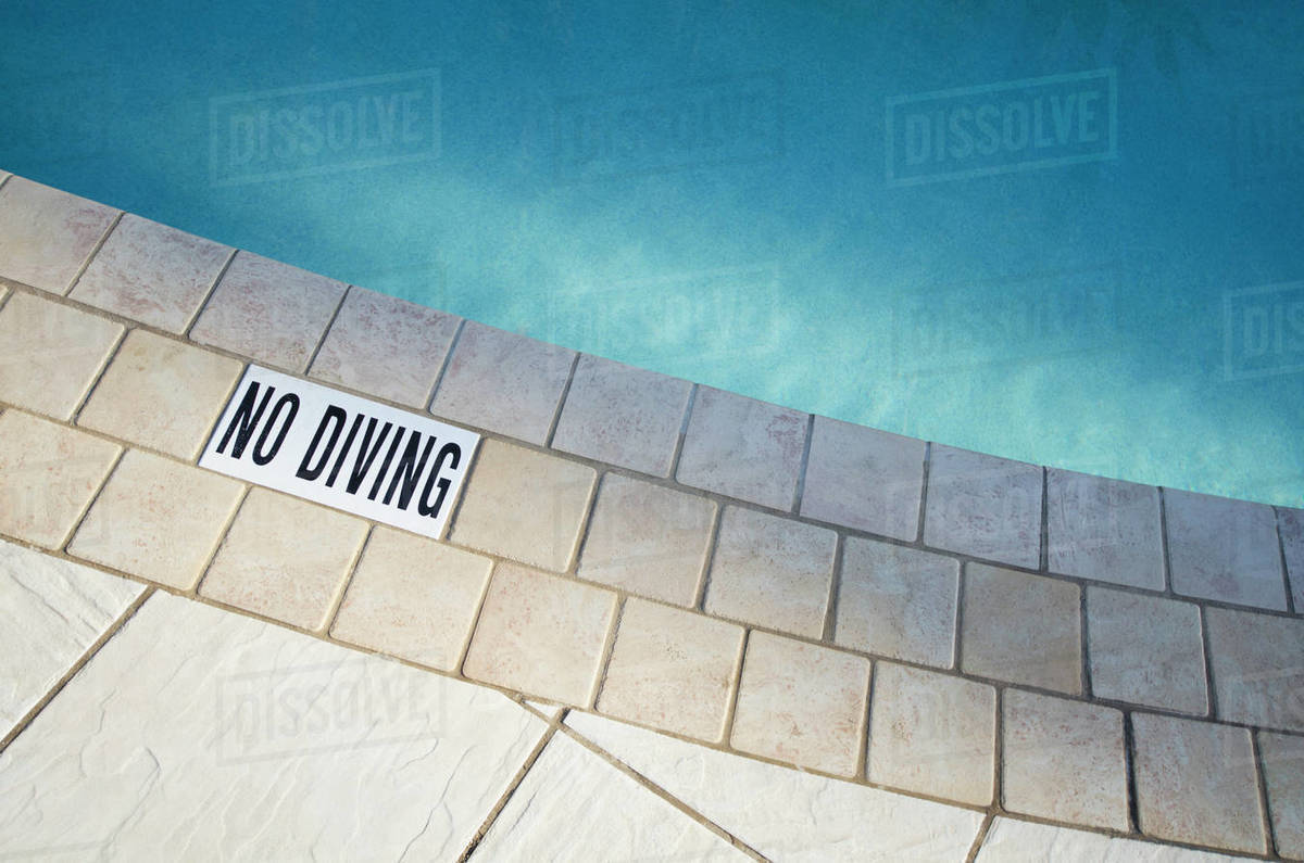 Warning sign at edge of swimming pool - Stock Photo - Dissolve