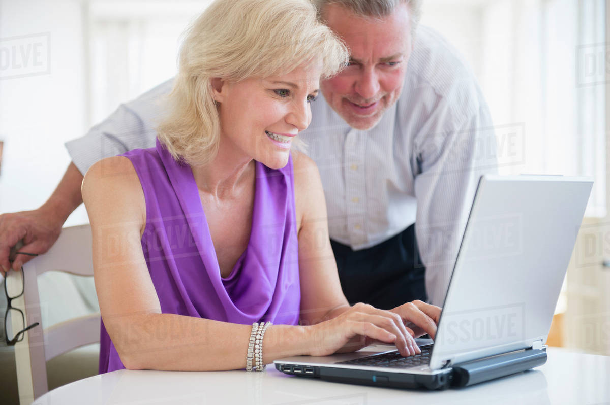 Portrait of couple looking at laptop screen - Royalty-free Stock Photo ...