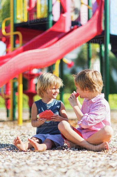 Boys (4-5, 8-9) playing on playground - Royalty-free Stock Photo | Dissolve