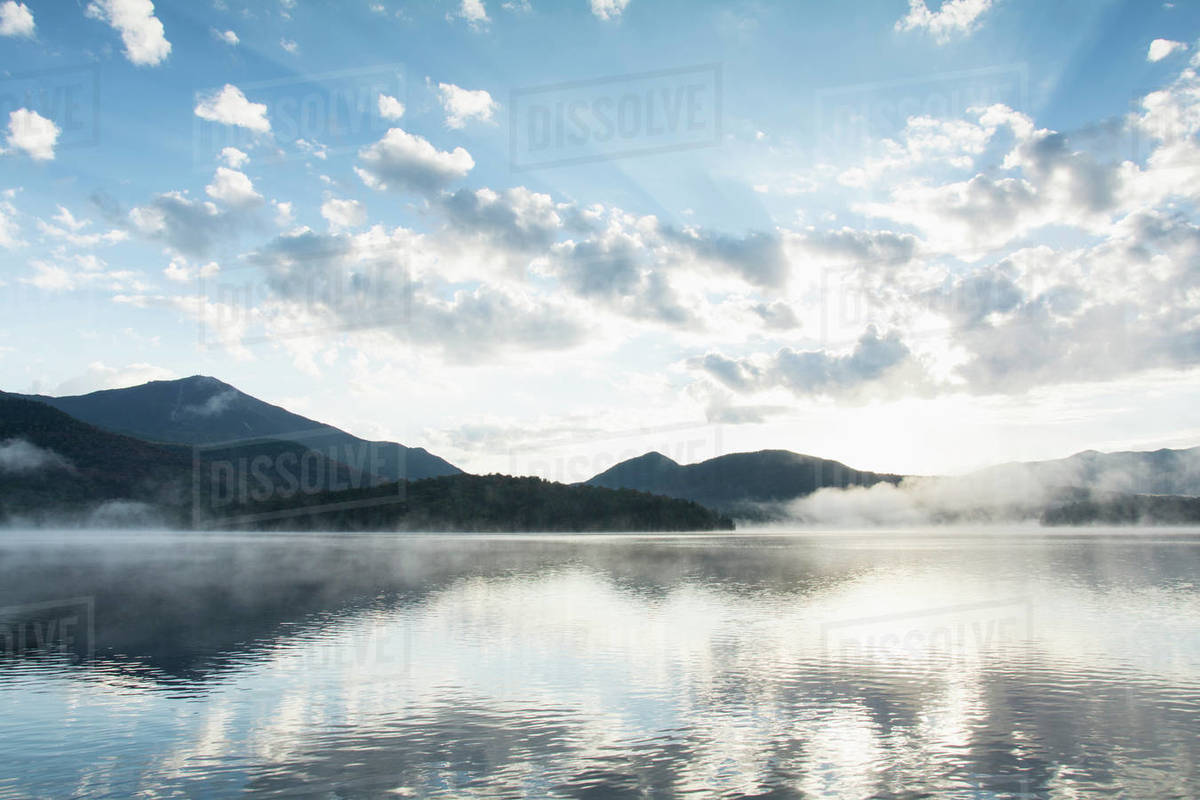 United States, New York, Lake Placid, Mountains and clouds reflected in ...