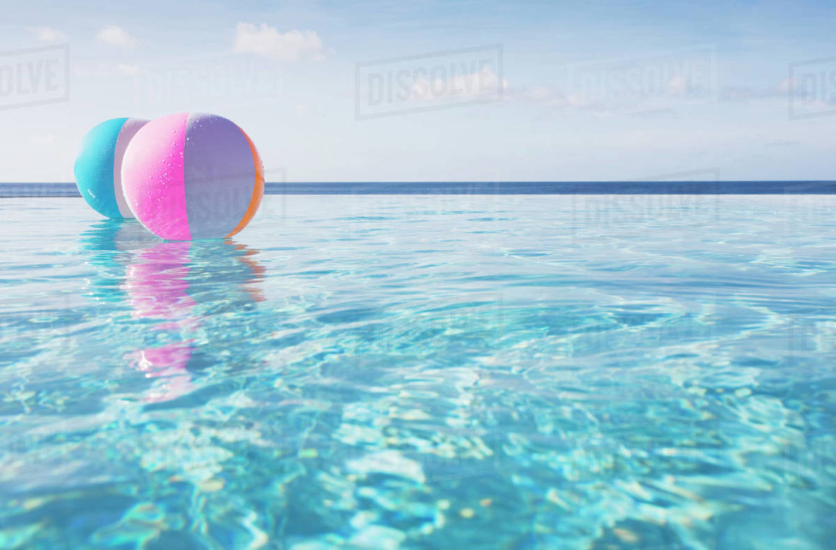 Beach balls floating on water in infinity pool - Royalty-free Stock ...