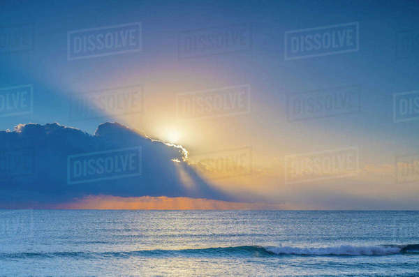 USA, Florida, Boca Raton, Sun rising behind clouds above sea - Stock ...
