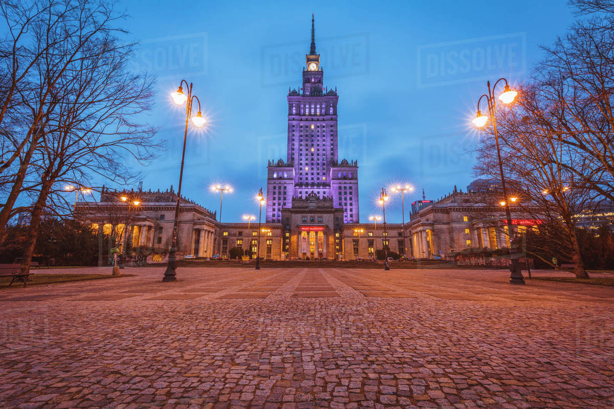 Poland, Masovia, Warsaw, Illuminated high rise building at town square ...