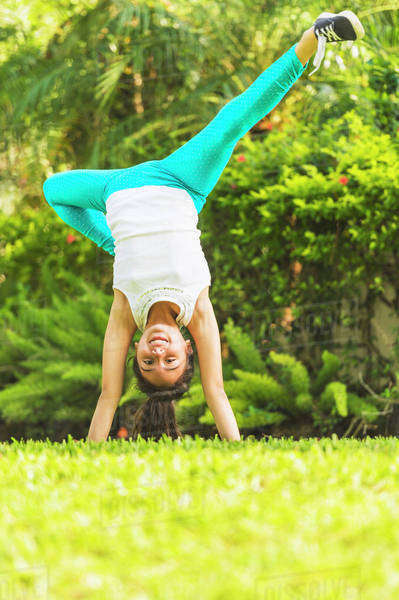 Girl (8-9) doing cartwheel on front yard - Royalty-free Stock Photo ...