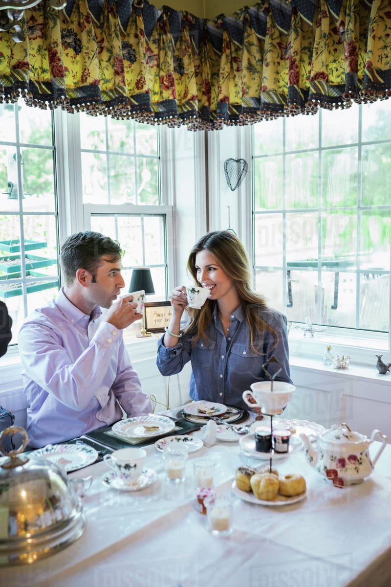 Couple eating together in dining room - Stock Photo - Dissolve