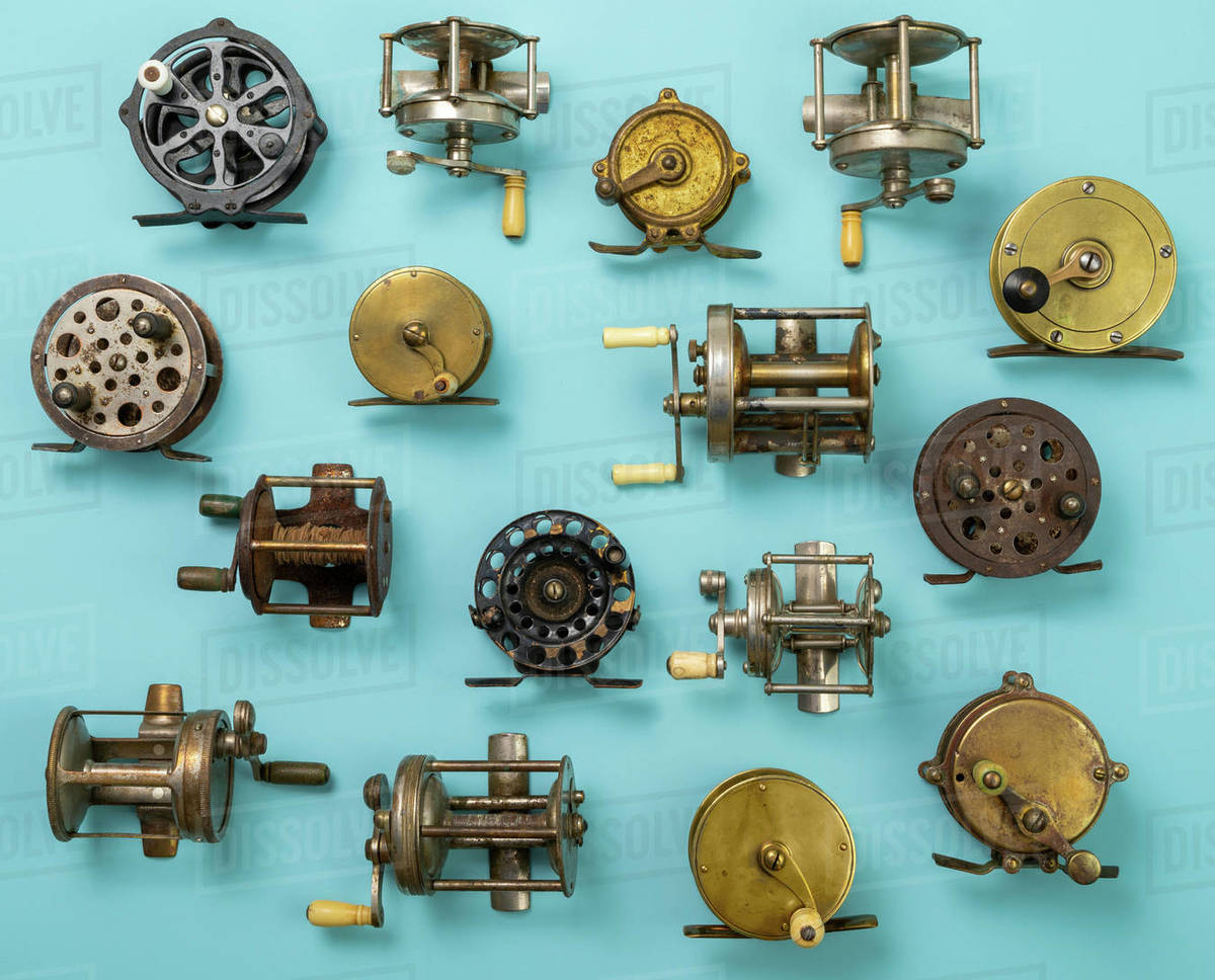 Vintage fishing reels on blue background - Stock Photo - Dissolve