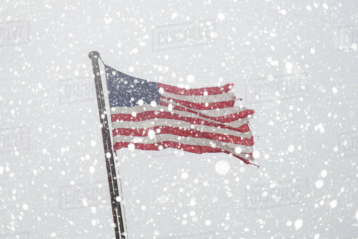 Torn American flag on flag pole with falling snow - Royalty-free Stock ...