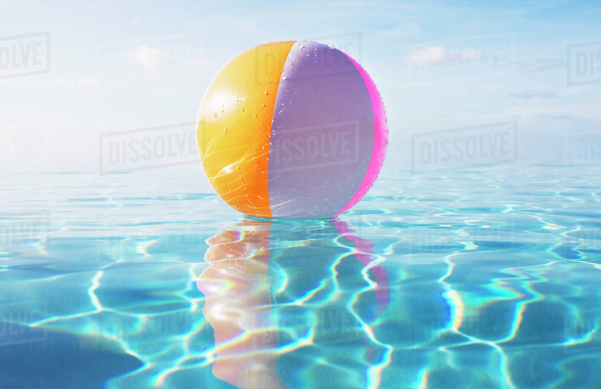 Beach ball floating on calm water surface - Royalty-free Stock Photo ...