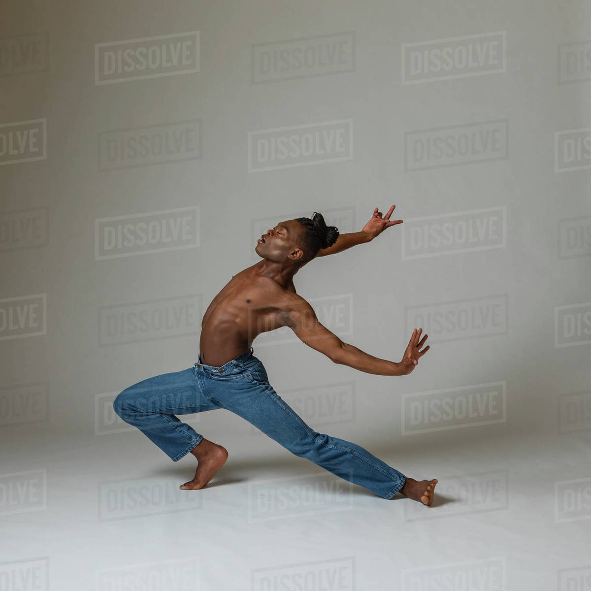 Studio shot of man dancing - Stock Photo - Dissolve