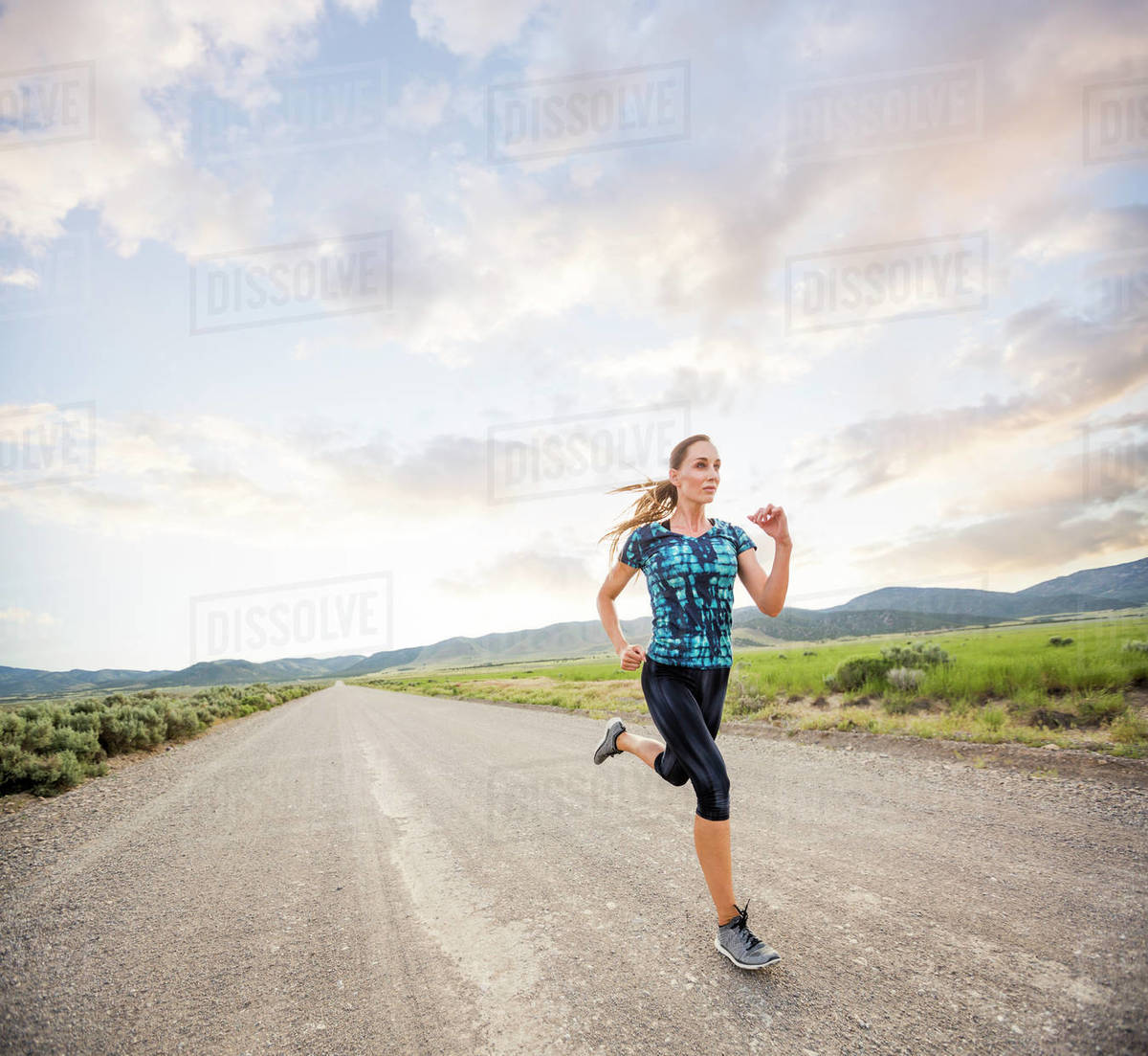 United States, Utah, Cedar Fort, Woman jogging on road in desert ...