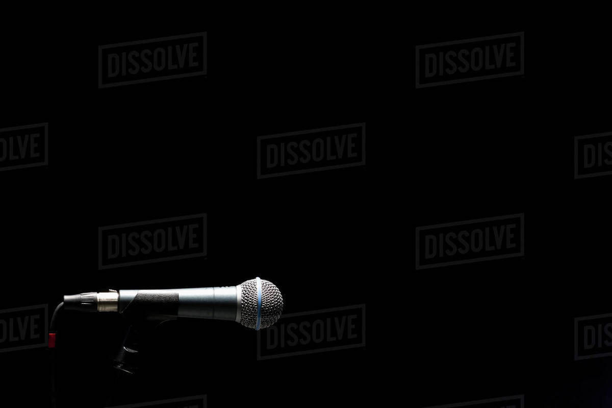 Studio shot of stage microphone - Stock Photo - Dissolve
