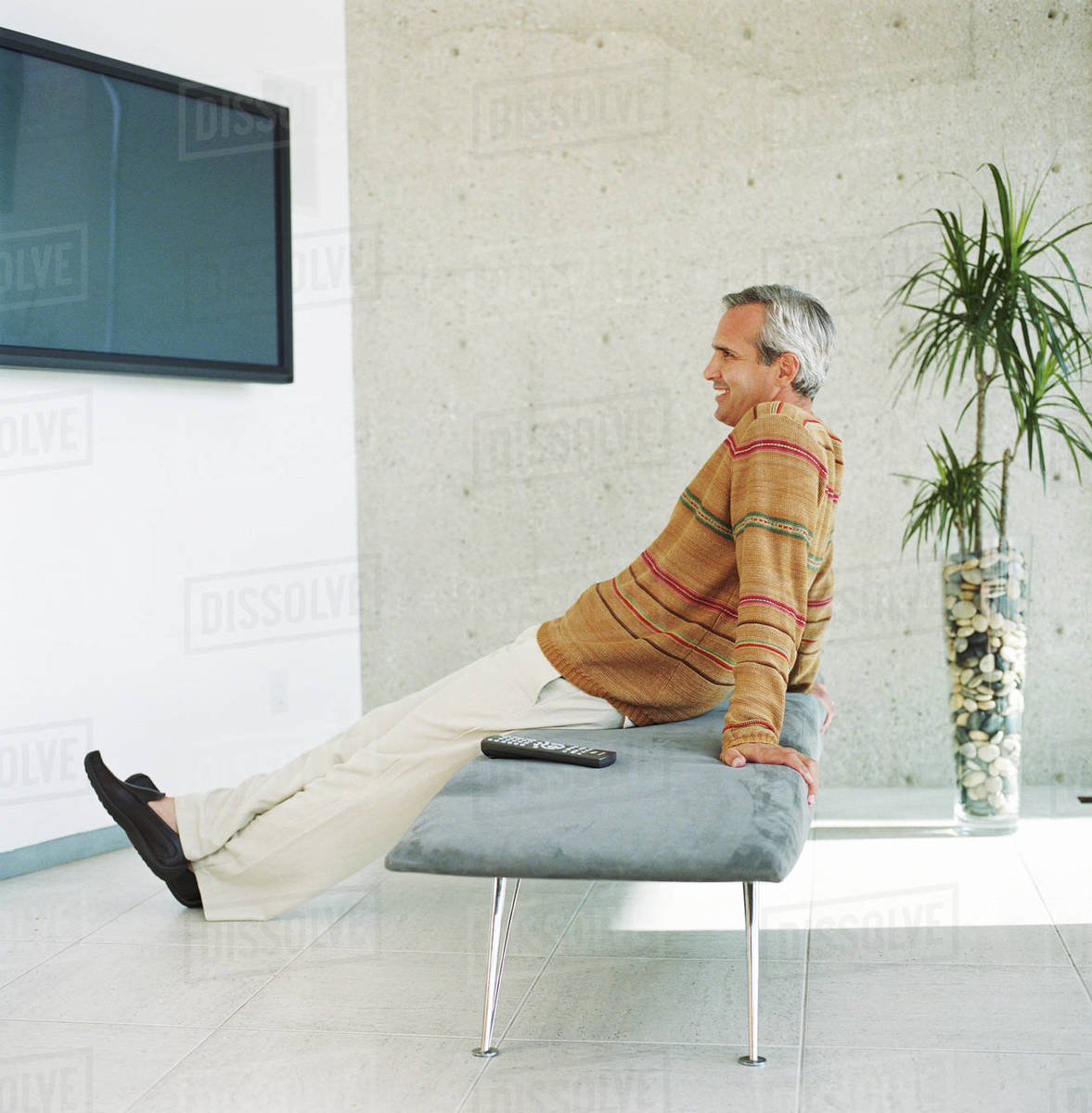 Man watching flat screen TV at home - Royalty-free Stock Photo | Dissolve