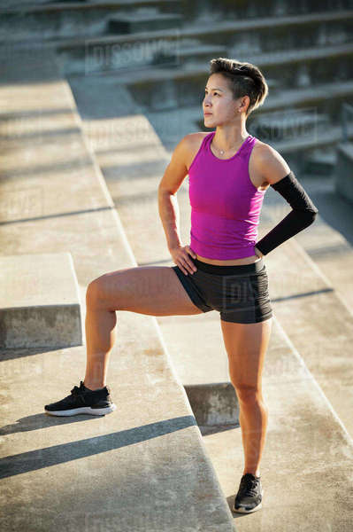 Athletic woman with amputated hand standing on steps - Royalty-free ...