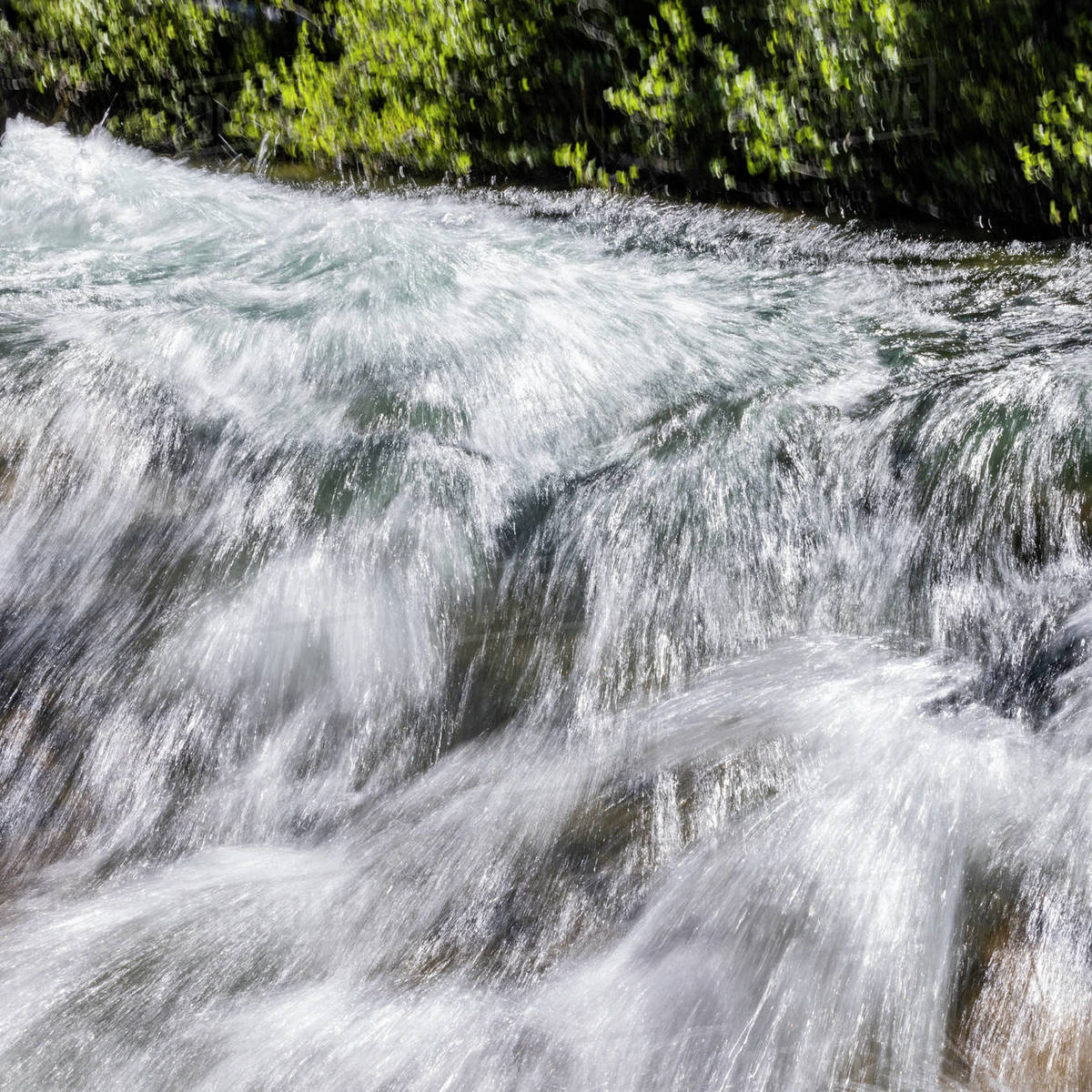 Blurred water of rushing creek - Royalty-free Stock Photo | Dissolve