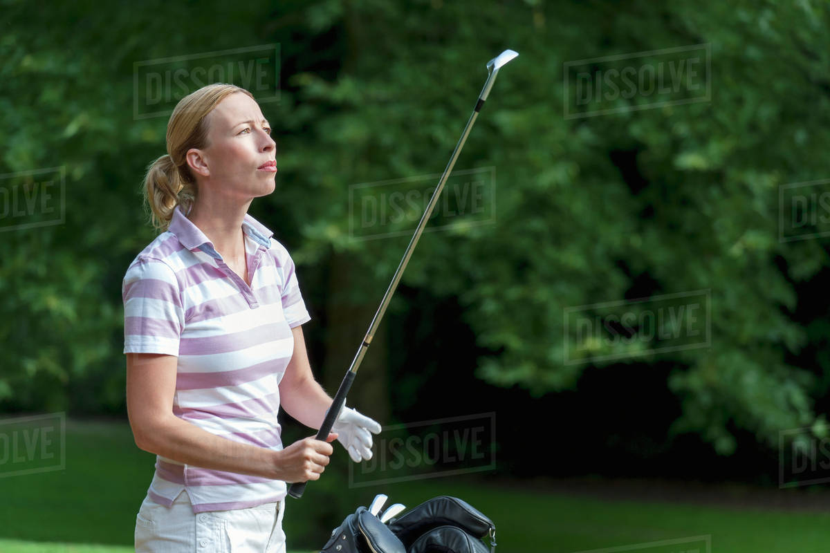 Woman on golf course - Stock Photo - Dissolve