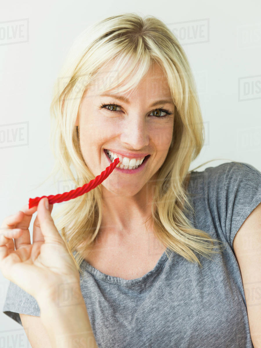 Woman eating candy - Stock Photo - Dissolve