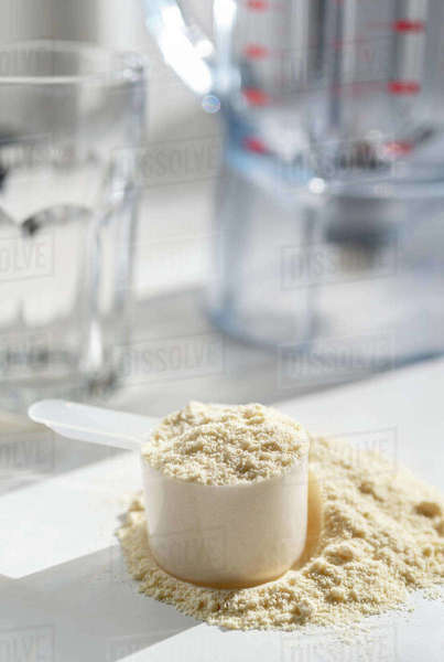 Protein powder in a plastic measuring cup with smoothie glass - Royalty ...