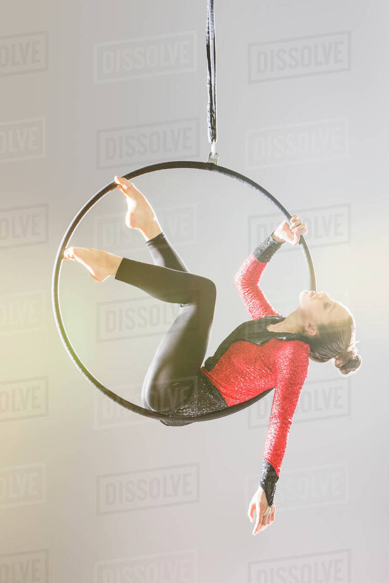Young acrobat performing on aerial hoop - Royalty-free Stock Photo ...