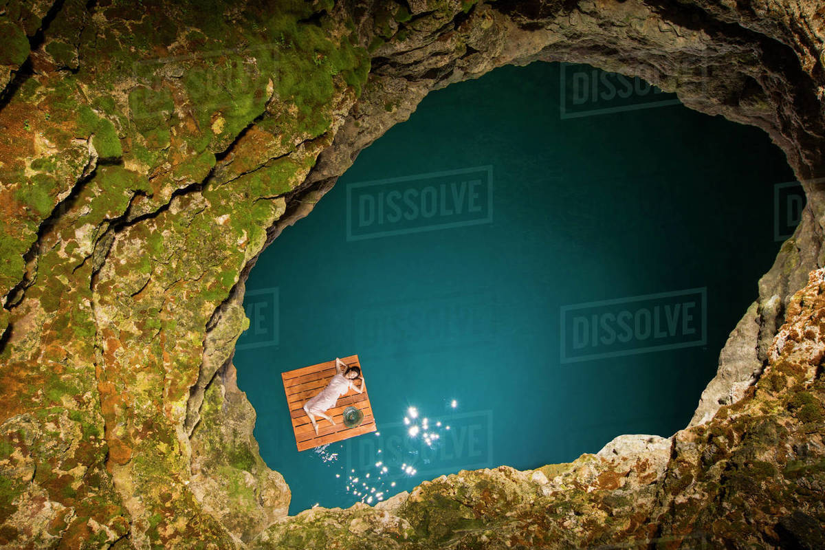 Aerial view of woman lying on wooden raft - Royalty-free Stock Photo ...