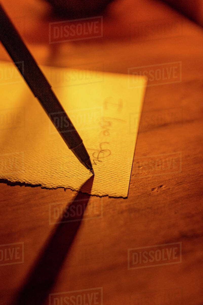 Close-up of pen writing on linen notecard - Stock Photo - Dissolve