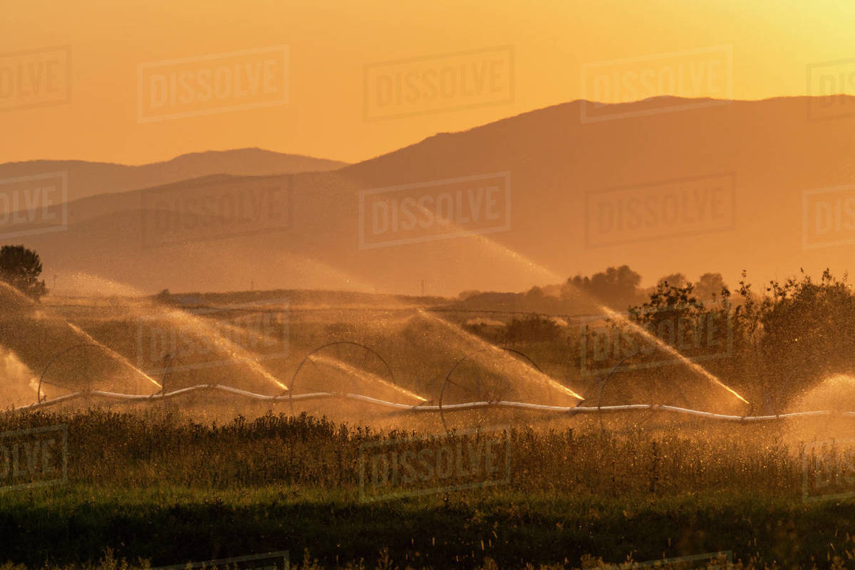 USA, Idaho, Bellevue, Farm irrigation system with mountain landscape in ...