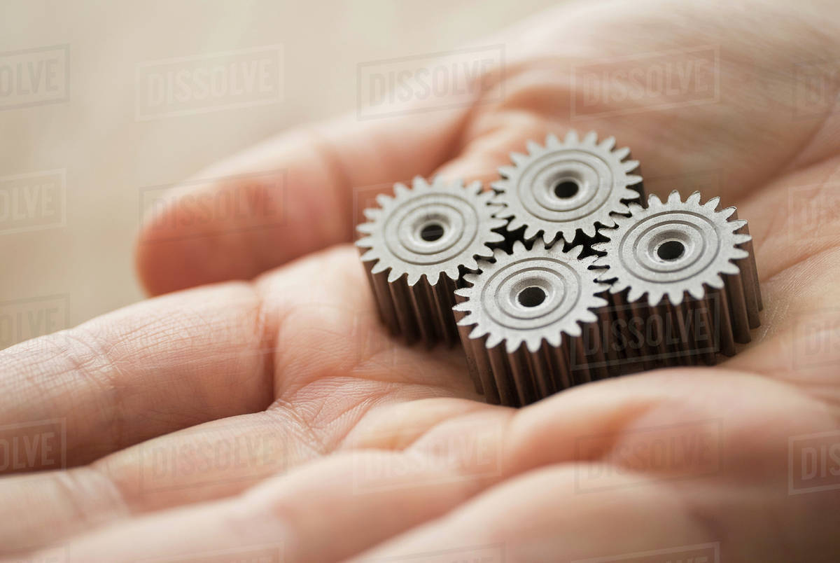 Close up of man's hand holding metal cogs - Royalty-free Stock Photo ...