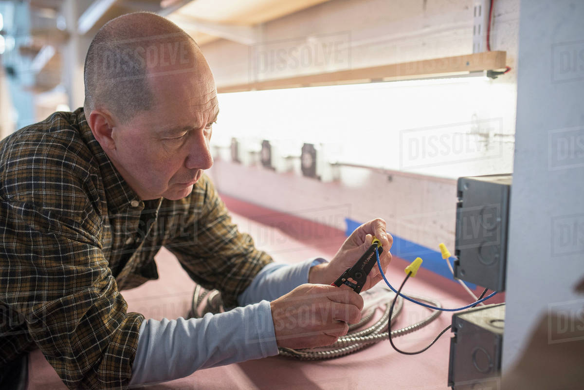 Electrician fixing wires - Royalty-free Stock Photo | Dissolve