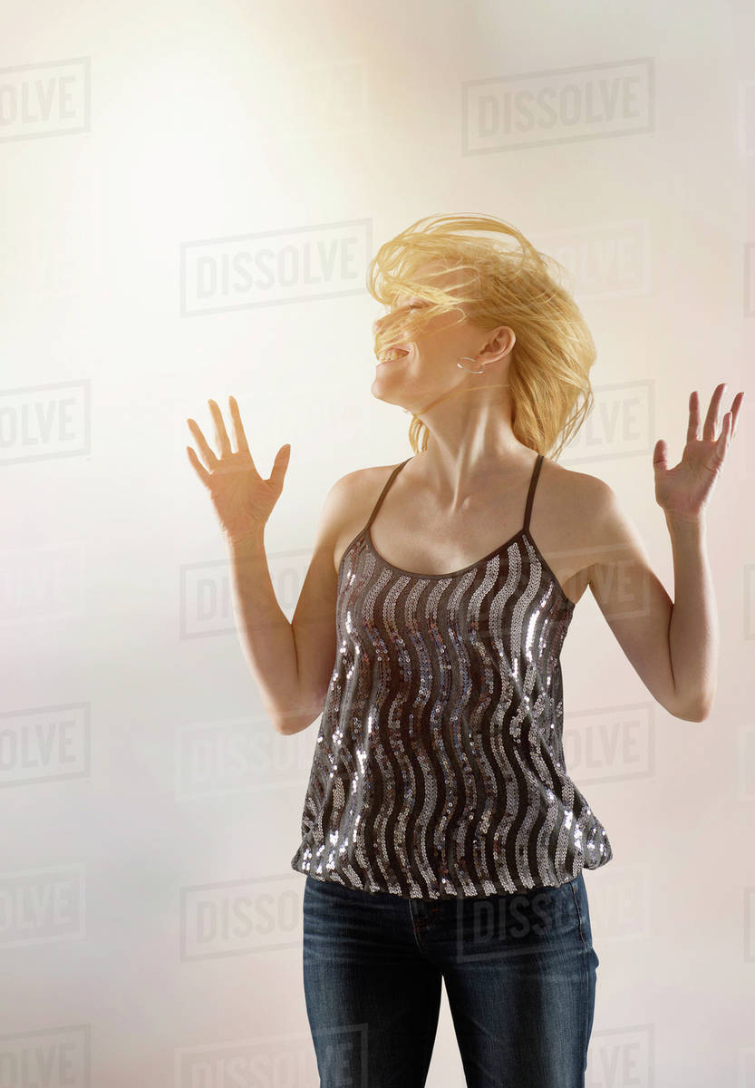 Happy woman dancing in studio - Royalty-free Stock Photo | Dissolve