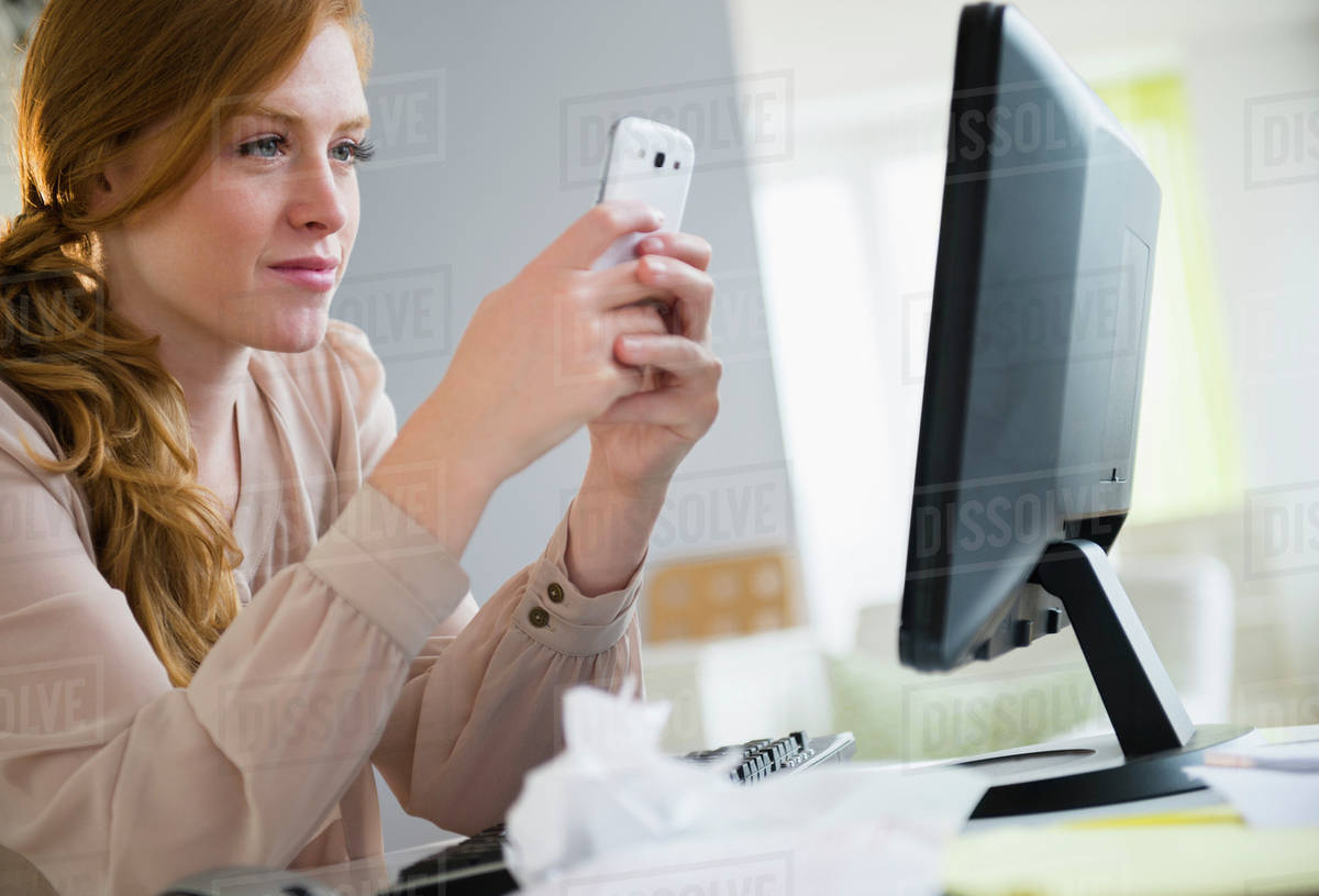 Young woman texting - Stock Photo - Dissolve