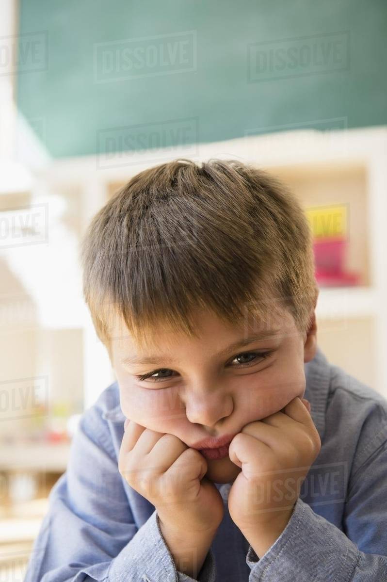 Portrait of frustrated boy (6-7) sitting in classroom - Royalty-free ...