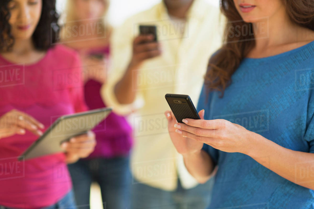 People using various digital devices - Royalty-free Stock Photo | Dissolve