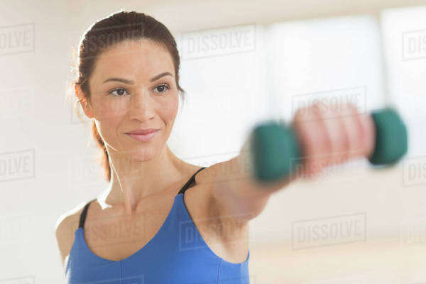 Portrait of woman lifting weights - Royalty-free Stock Photo | Dissolve