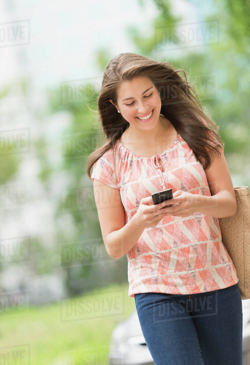 Woman texting on phone - Royalty-free Stock Photo | Dissolve