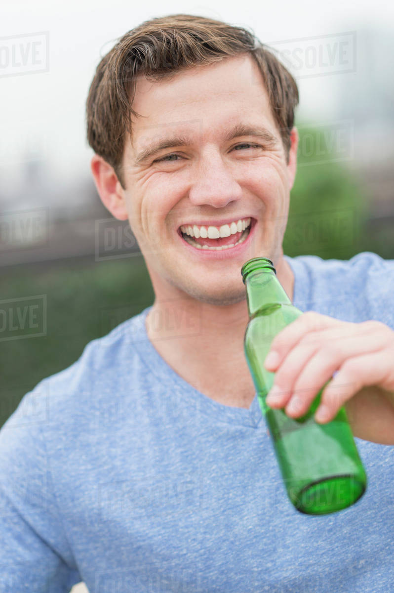 Portrait of man drinking beer - Stock Photo - Dissolve