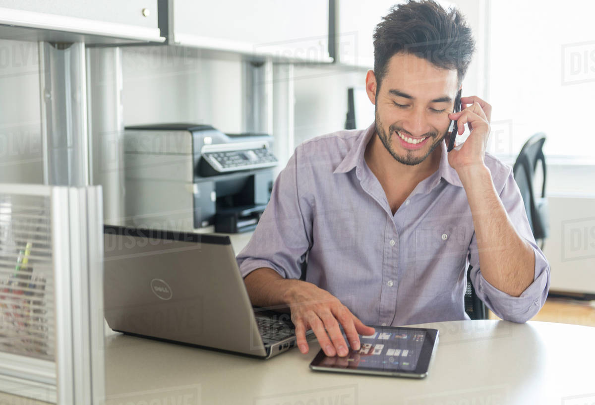 Man using technology in office - Stock Photo - Dissolve