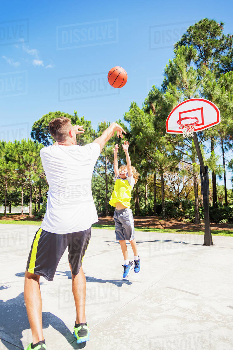 Boy (8-9) playing basketball with his brother - Royalty-free Stock ...