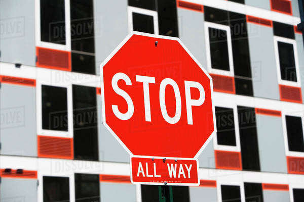 Stop sign with building in background - Stock Photo - Dissolve