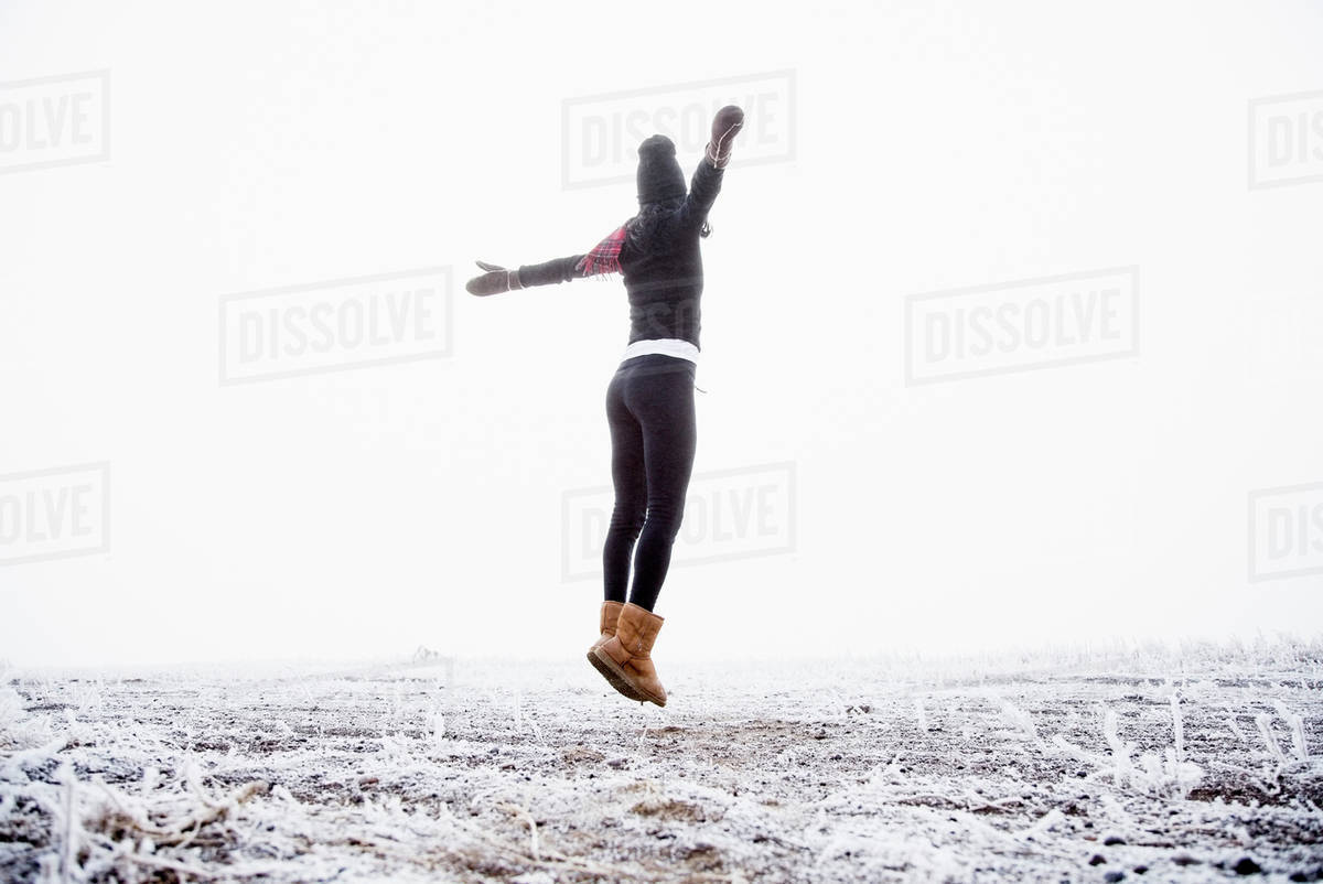 Woman jumping outdoors - Stock Photo - Dissolve