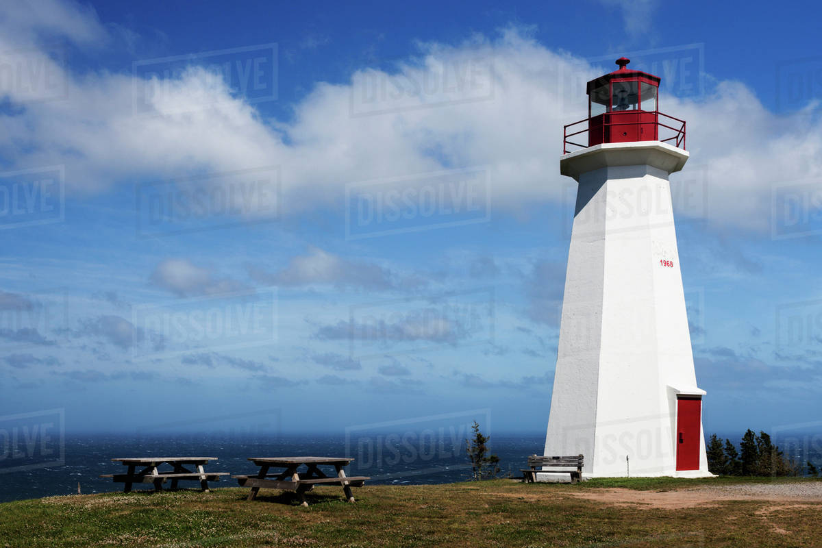 Picnic tables next to Cape George Lighthouse with sea on background ...