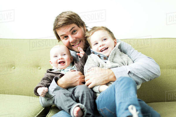 Father embracing two sons (6-11 months and 2-3 years) - Royalty-free ...