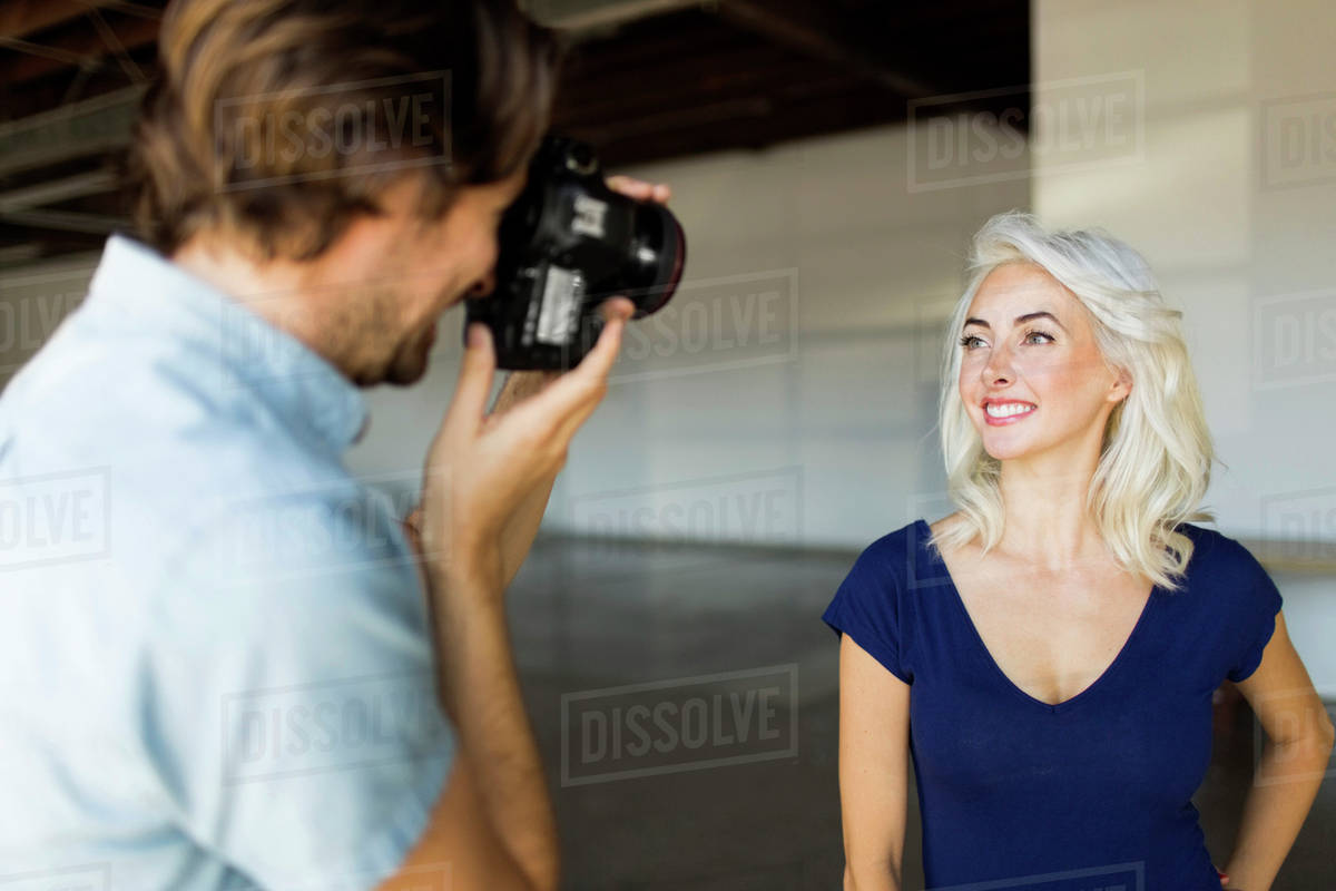 Man photographing woman - Royalty-free Stock Photo | Dissolve